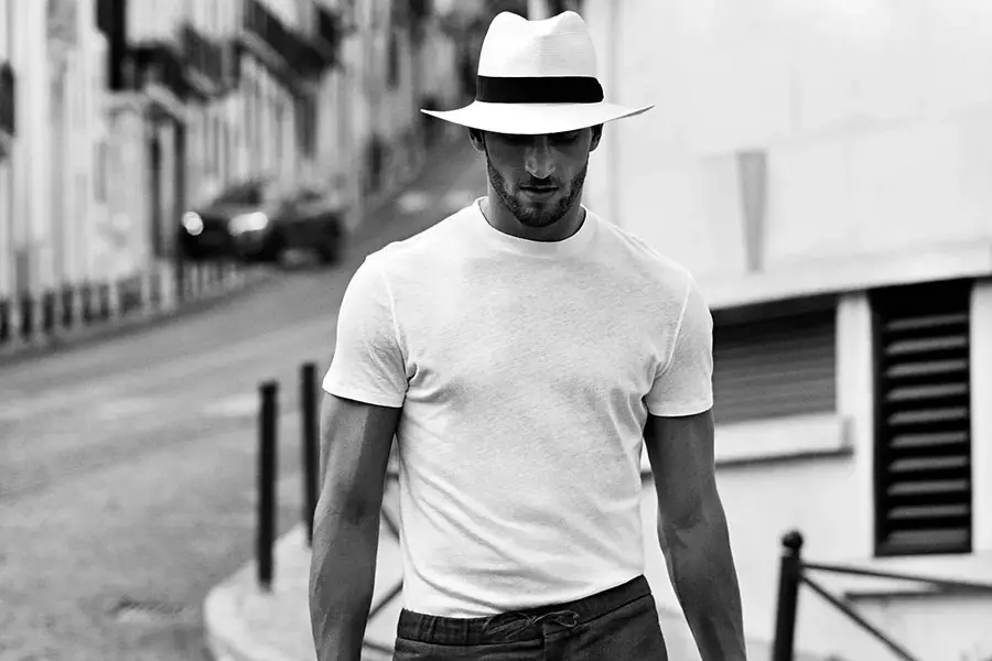 Мужчина в белой футболке и фетровой шляпе