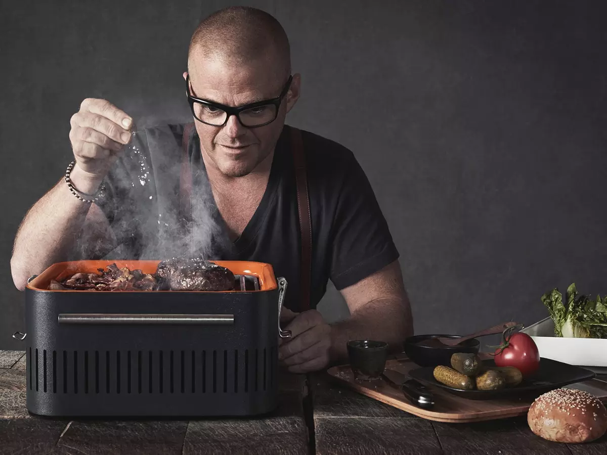 man cooking on everdure by heston blumenthal cube charcoal portable barbeque