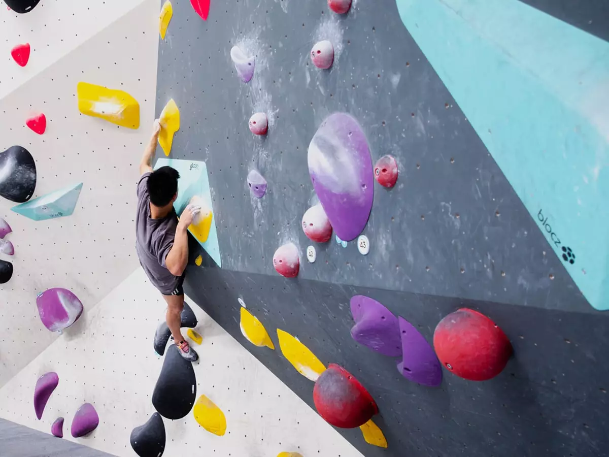 man climbing wall ing blochaus bouldering